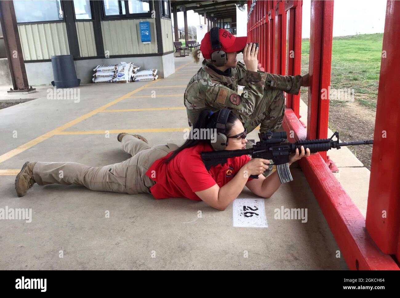 Jessie Ramirez practices her shooting skills as Staff Sgt. Chloee Lamb ...