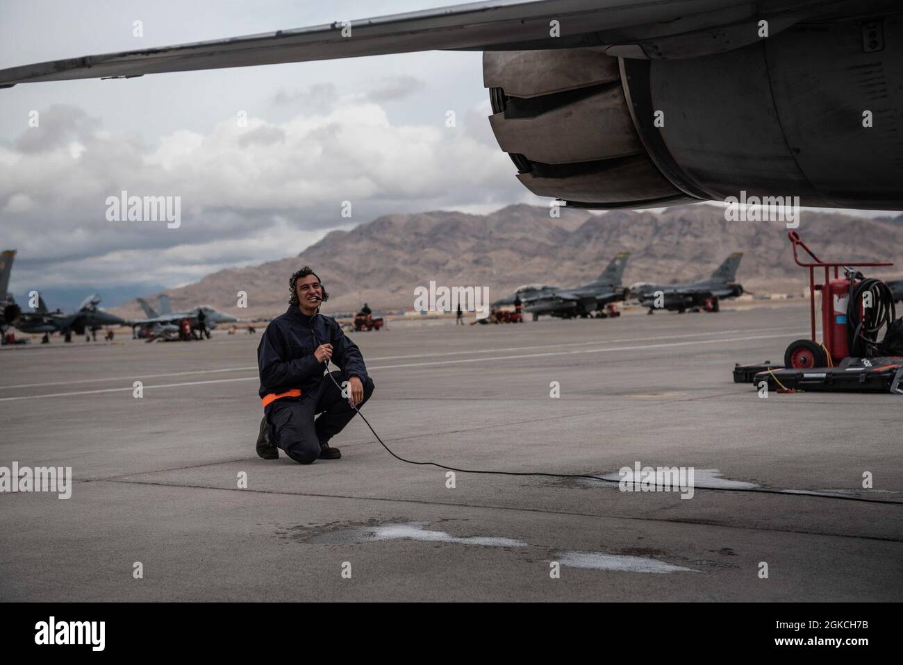 An F-16 Viper crew chief performs a final inspection on an aircraft ...