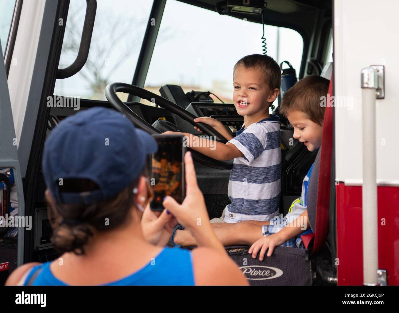 A mother photographs her children in a fire truck during the Tåotåo ...