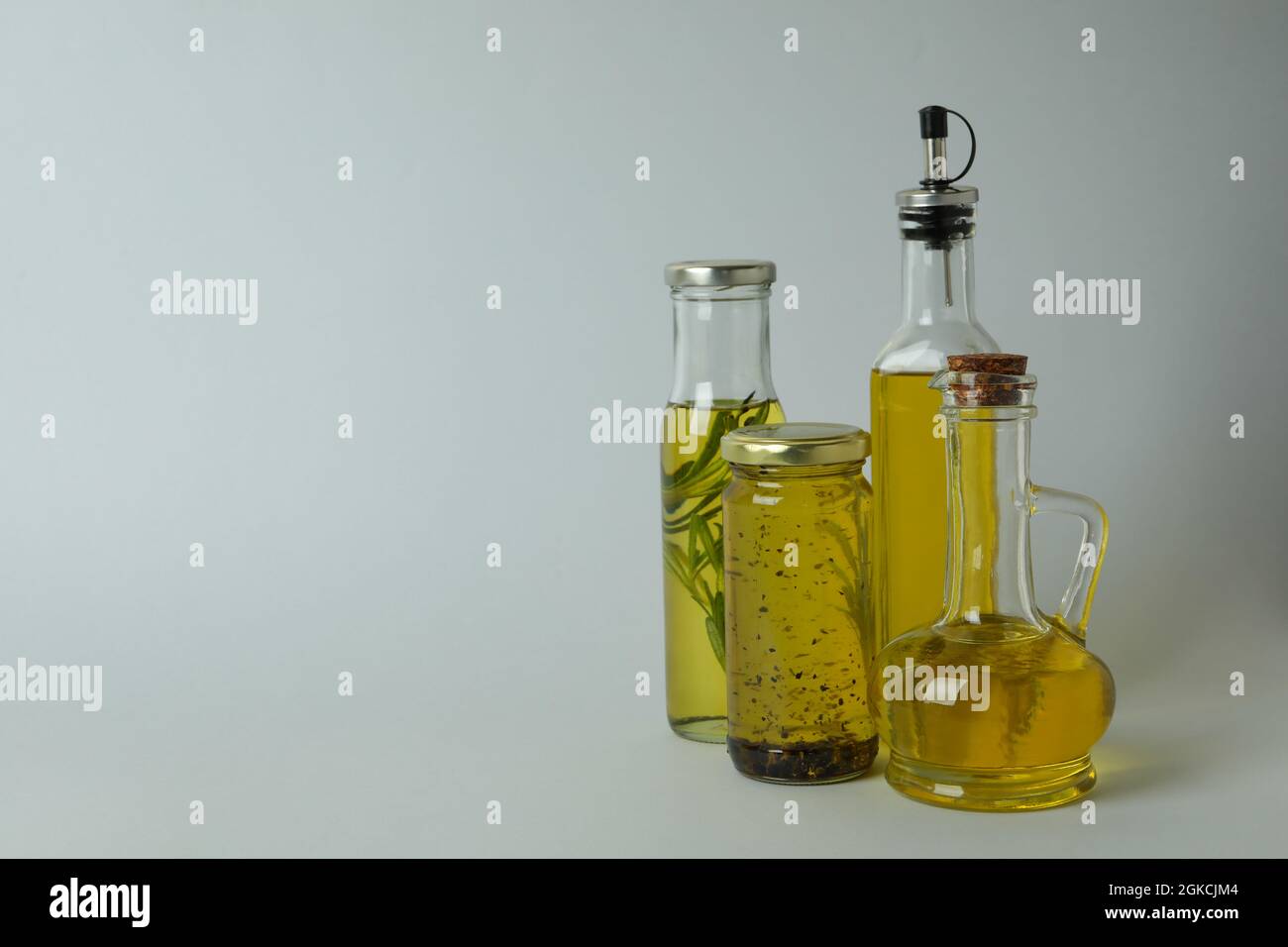 Set of different oils on light gray background Stock Photo - Alamy