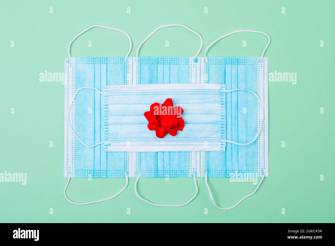 Composition of face masks with red ribbon on green background Stock ...