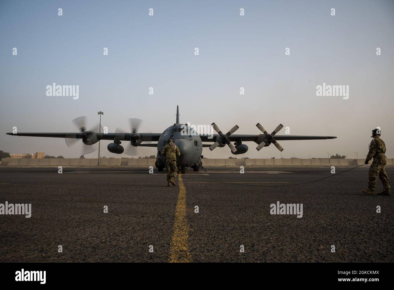 A U.S. Air Force loadmaster and crew chief watch engine start up on a C ...