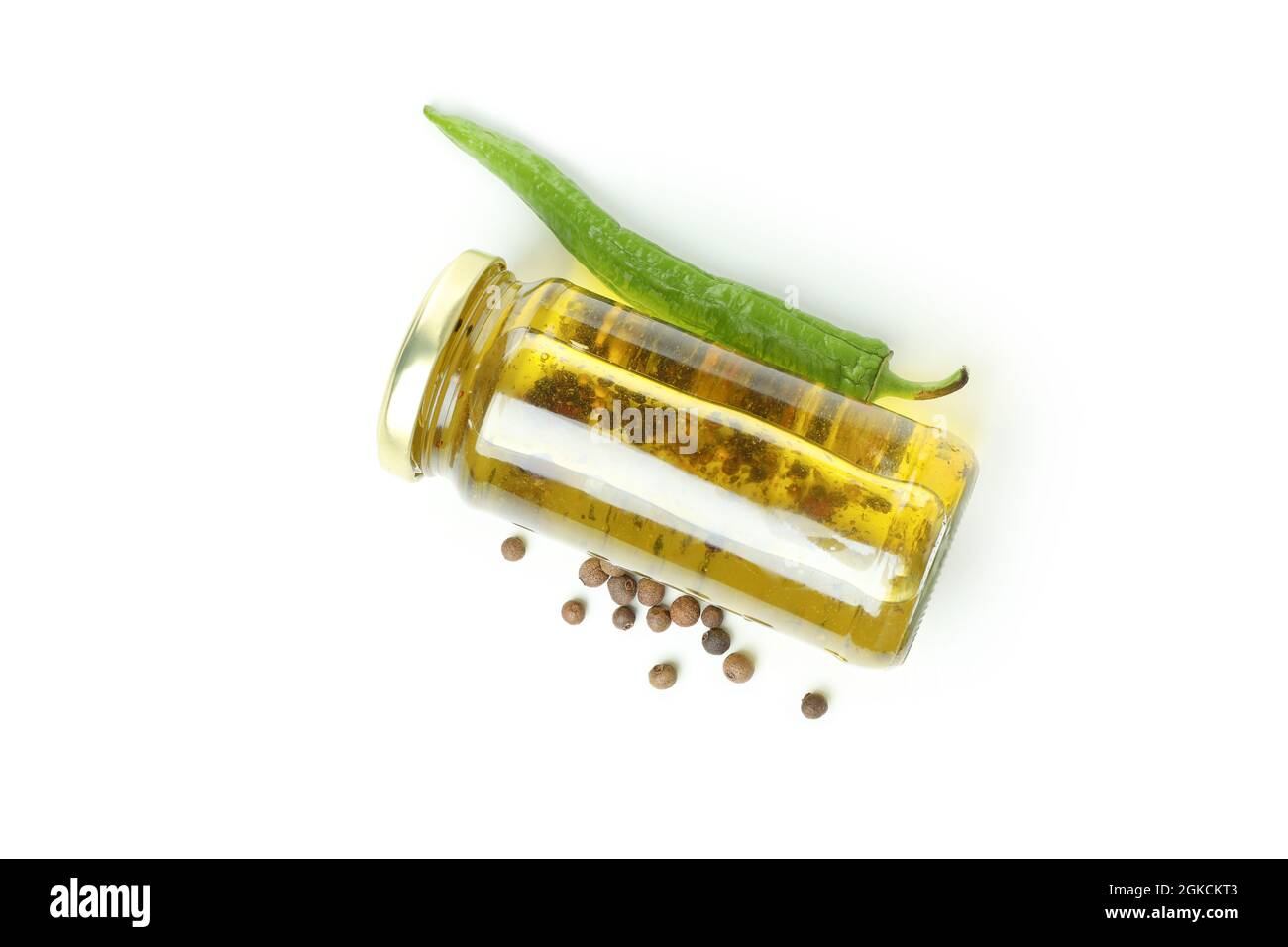 Glass jar of oil isolated on white background Stock Photo - Alamy