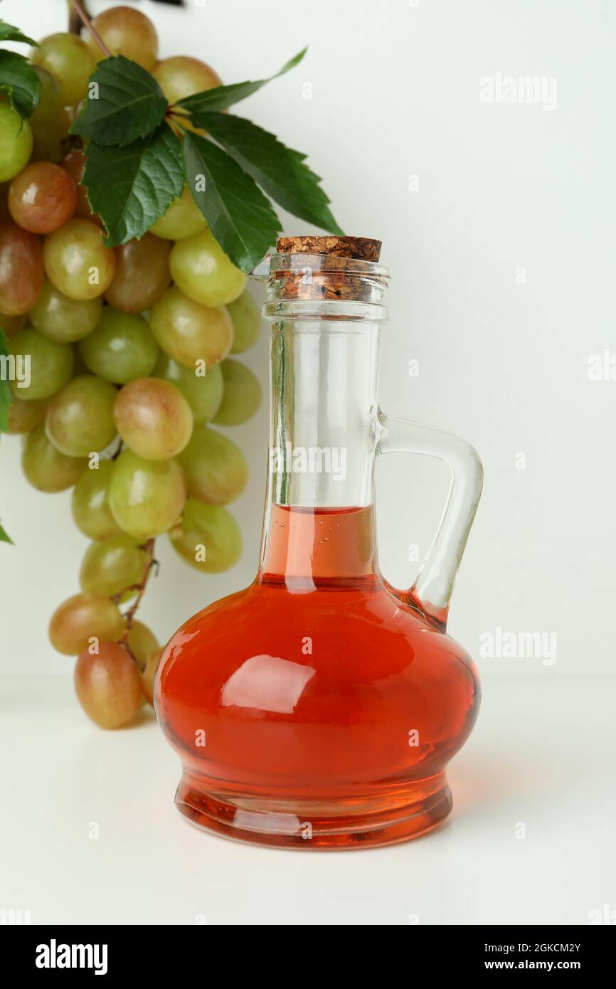 Concept of grape vinegar on white background Stock Photo - Alamy
