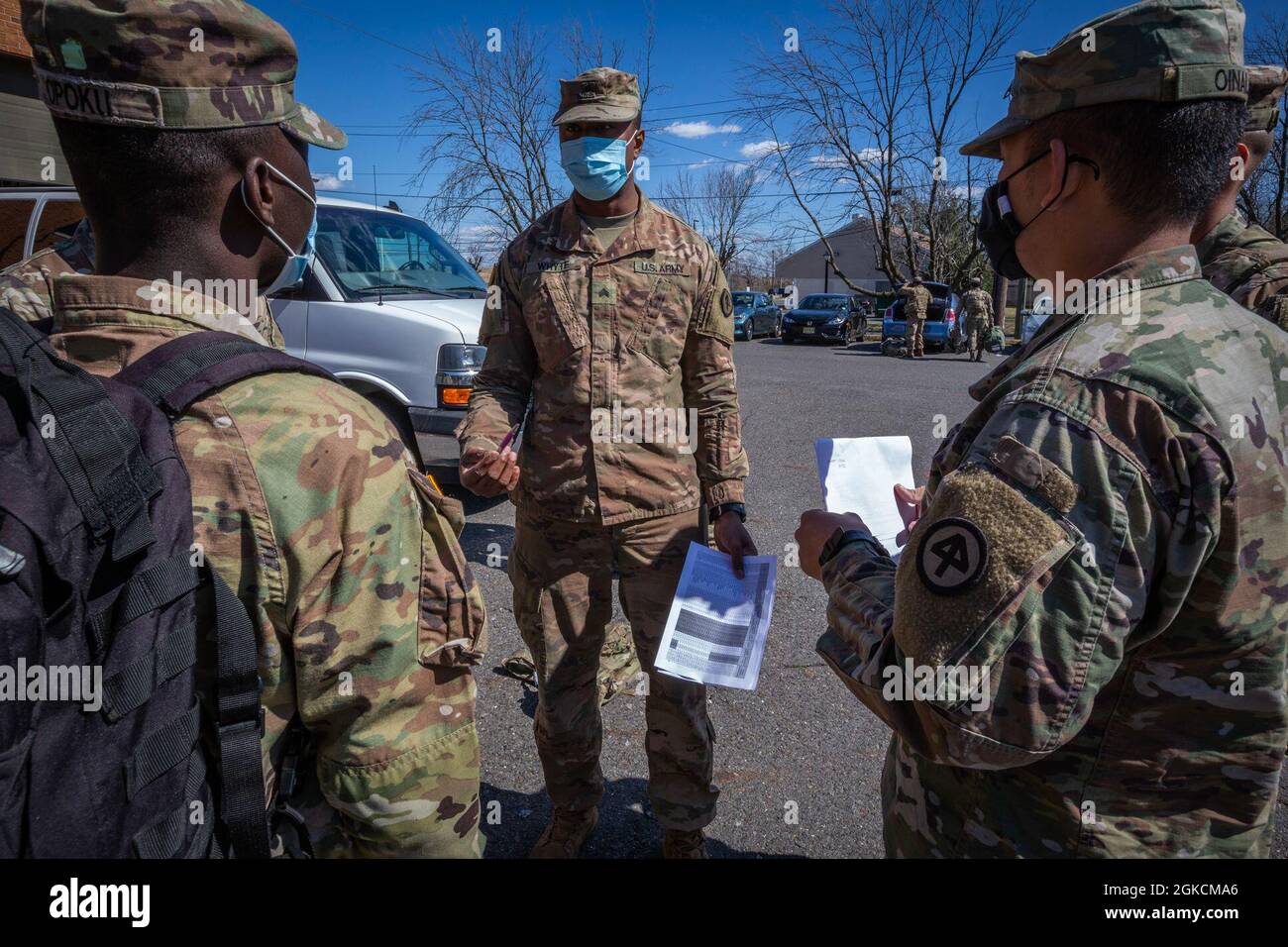U.S. Army Sgt. Shavon A. Whyte, center, blue mask, Hotel Company, 250th ...