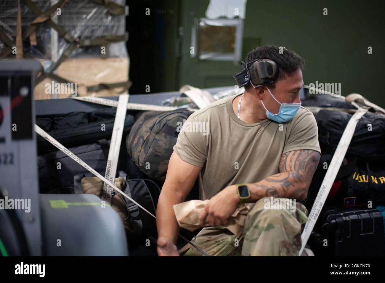 An Airman from the 154th Maintenance Group secures equipment on a C-17 ...