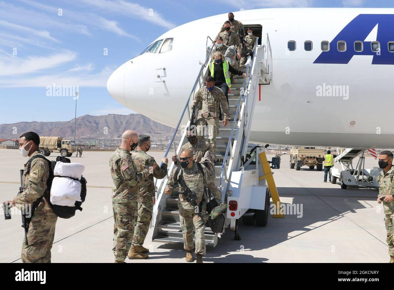 Soldiers from the 2nd Brigade Combat Team, 1st Armored Division exit their plane after returning ...