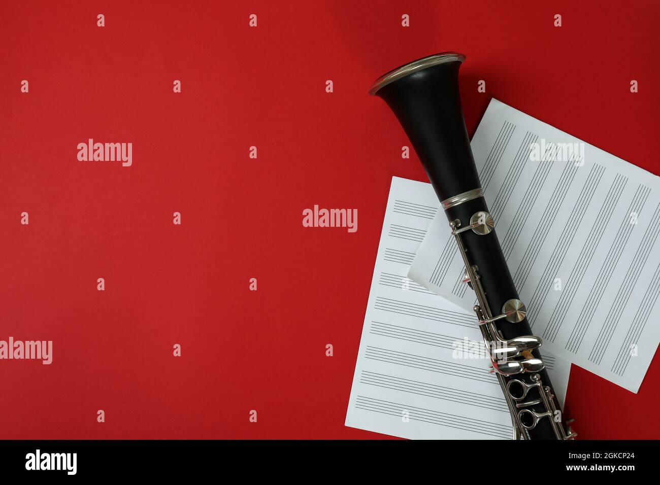 Clarinet and music sheets on red background Stock Photo - Alamy