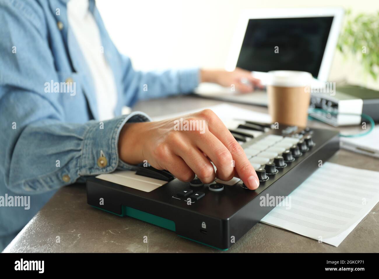 Musical producer working on his workplace on gray textured table Stock ...