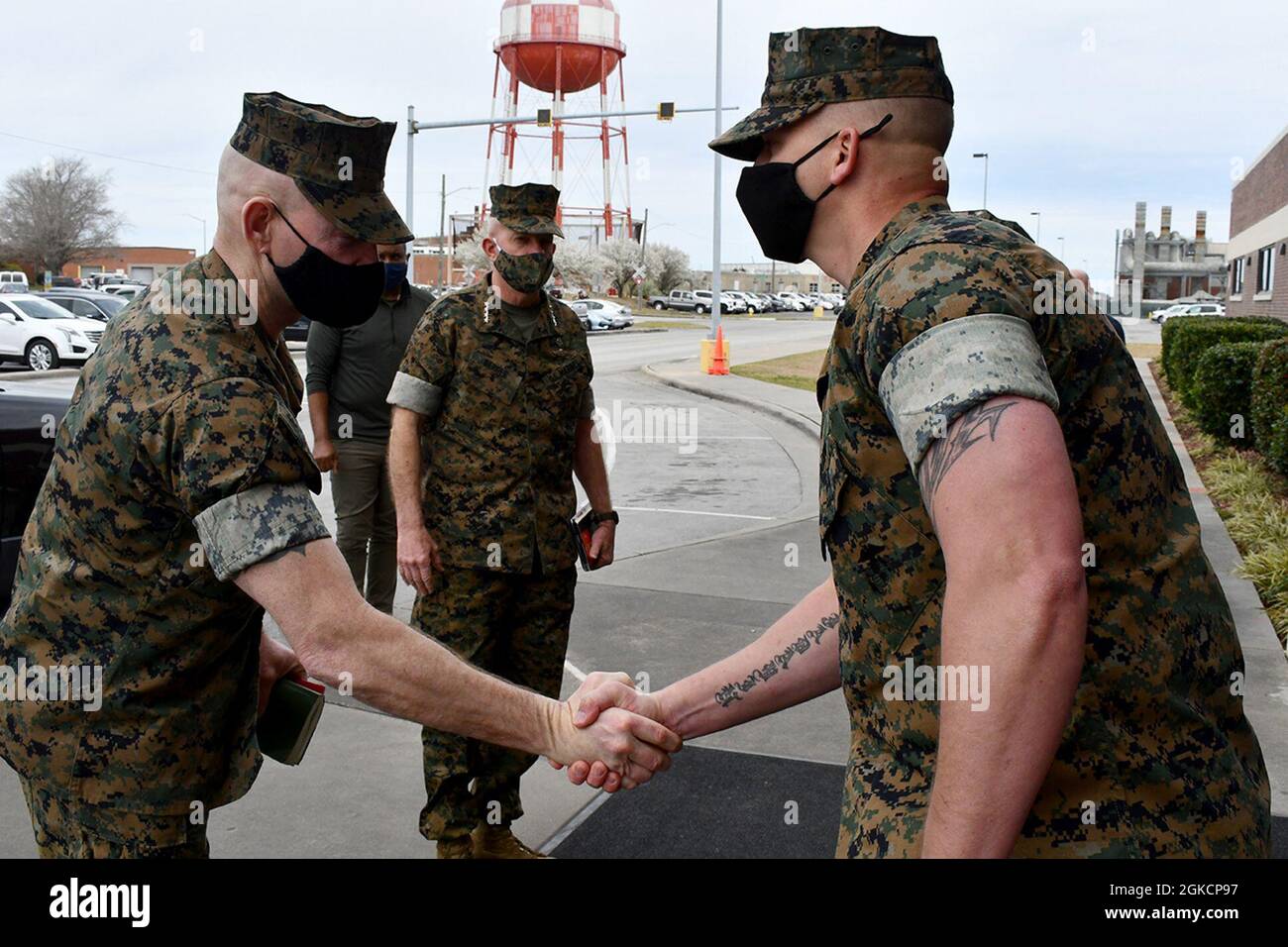 Fleet Readiness Center East 1st Sgt. Nathaniel J. Eirich, right, greets ...