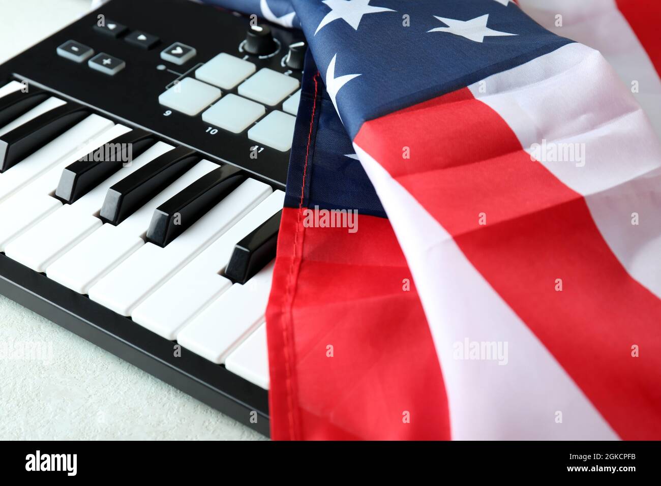 Midi keyboard and american flag on white textured background Stock ...