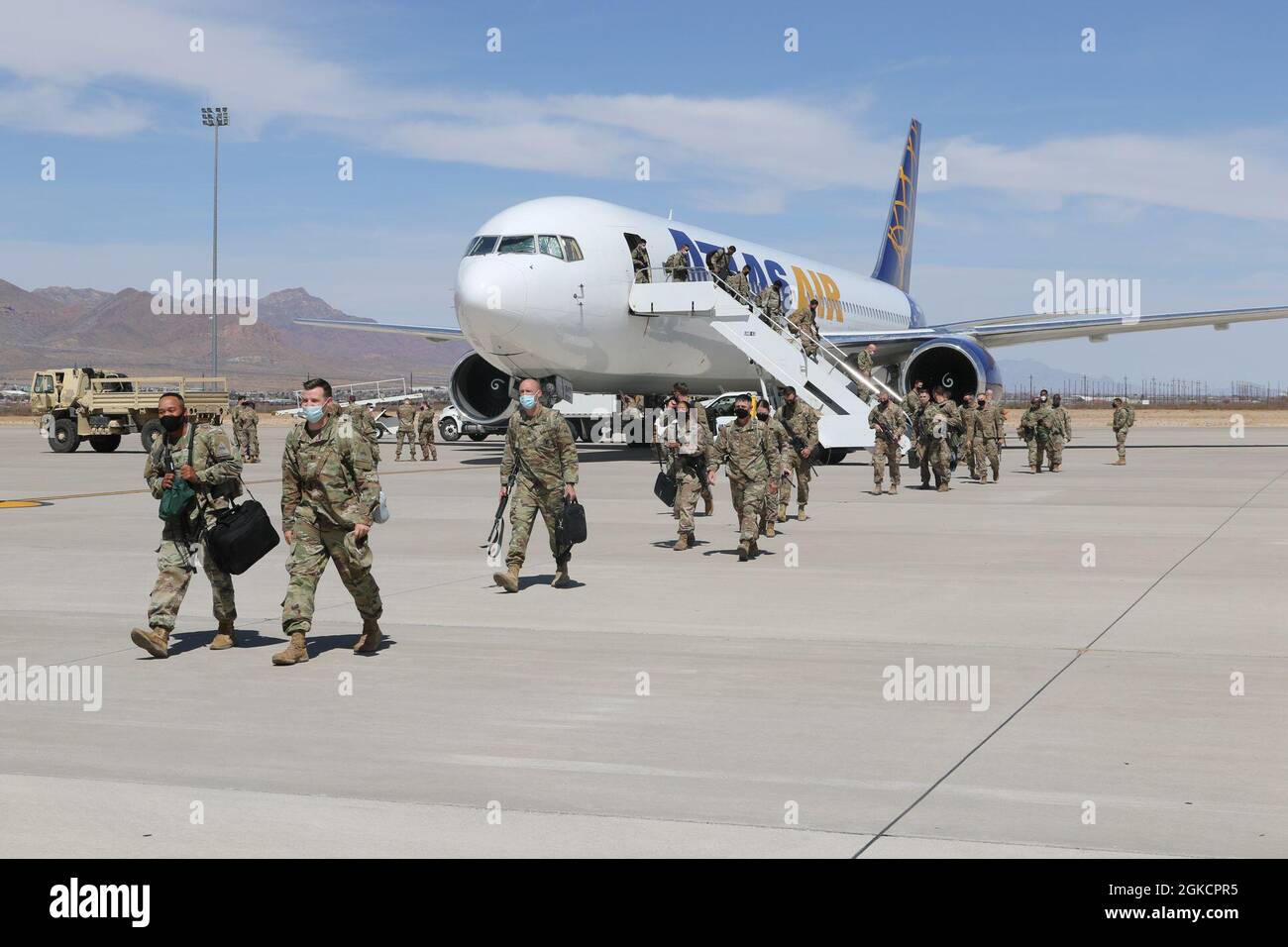 Soldiers from the 2nd Brigade Combat Team, 1st Armored Division exit their plane after returning ...