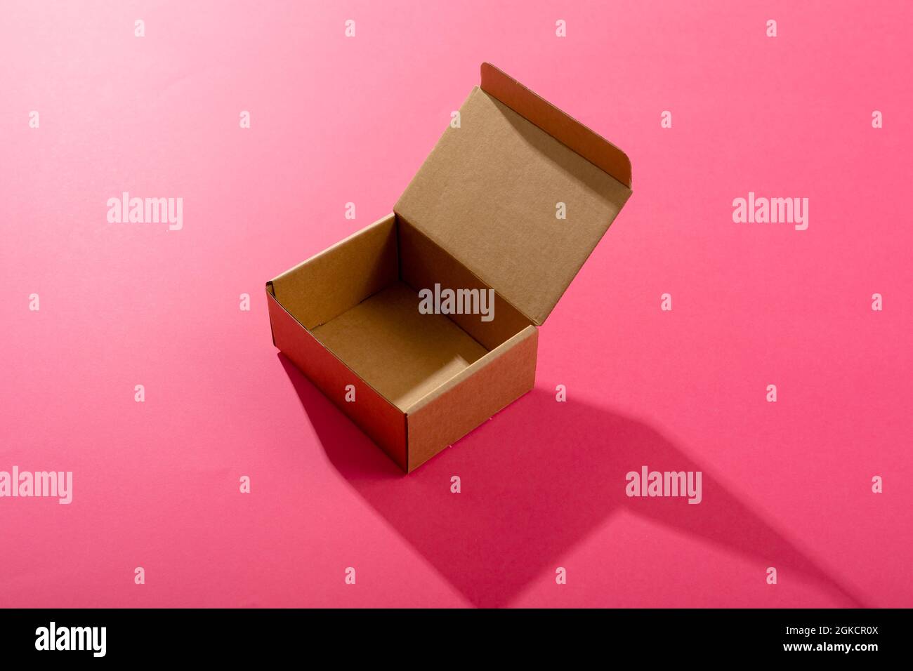 Composition of open empty cardboard gift box on pink background Stock ...