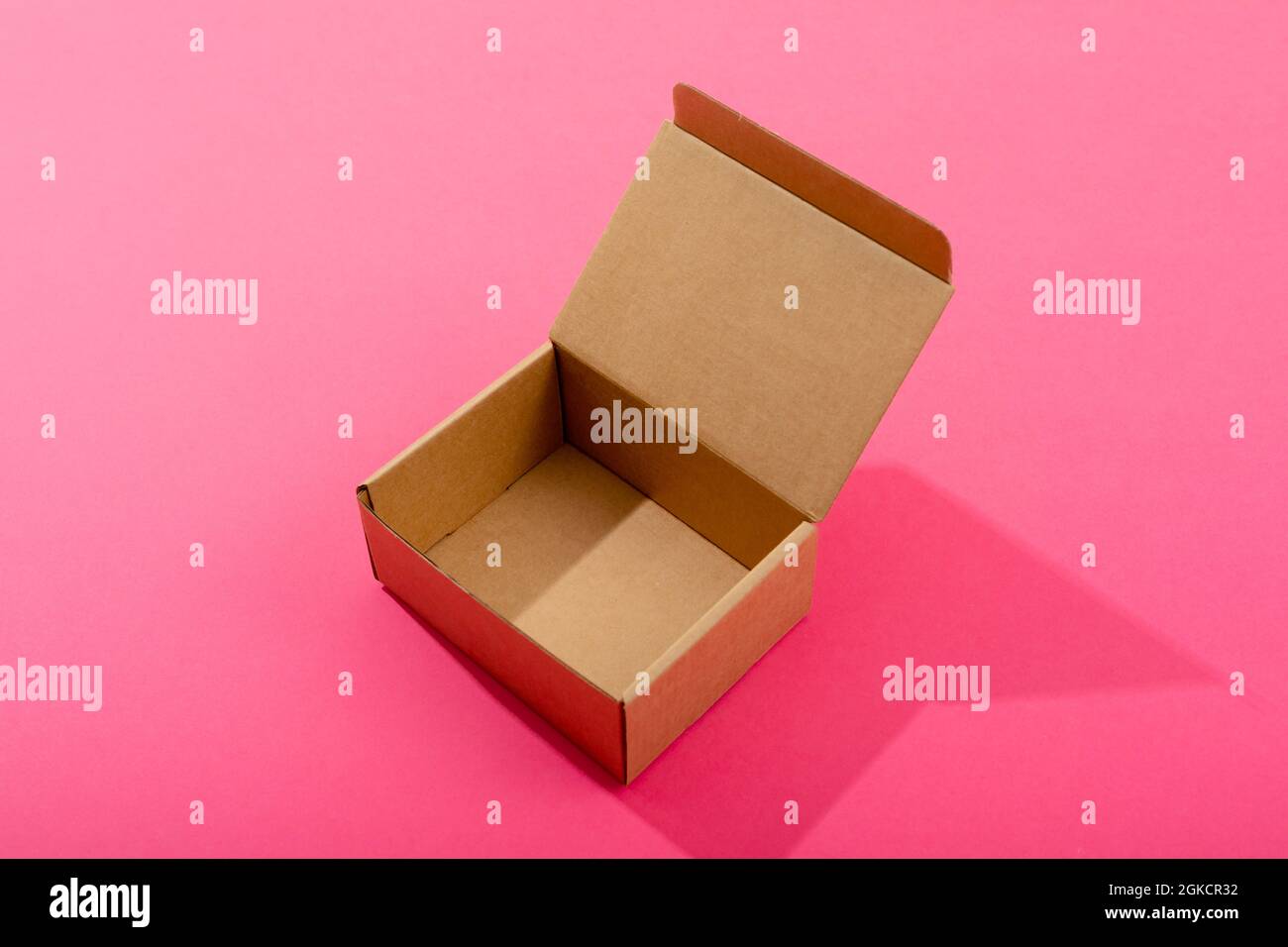 Composition of open empty cardboard gift box on pink background Stock ...