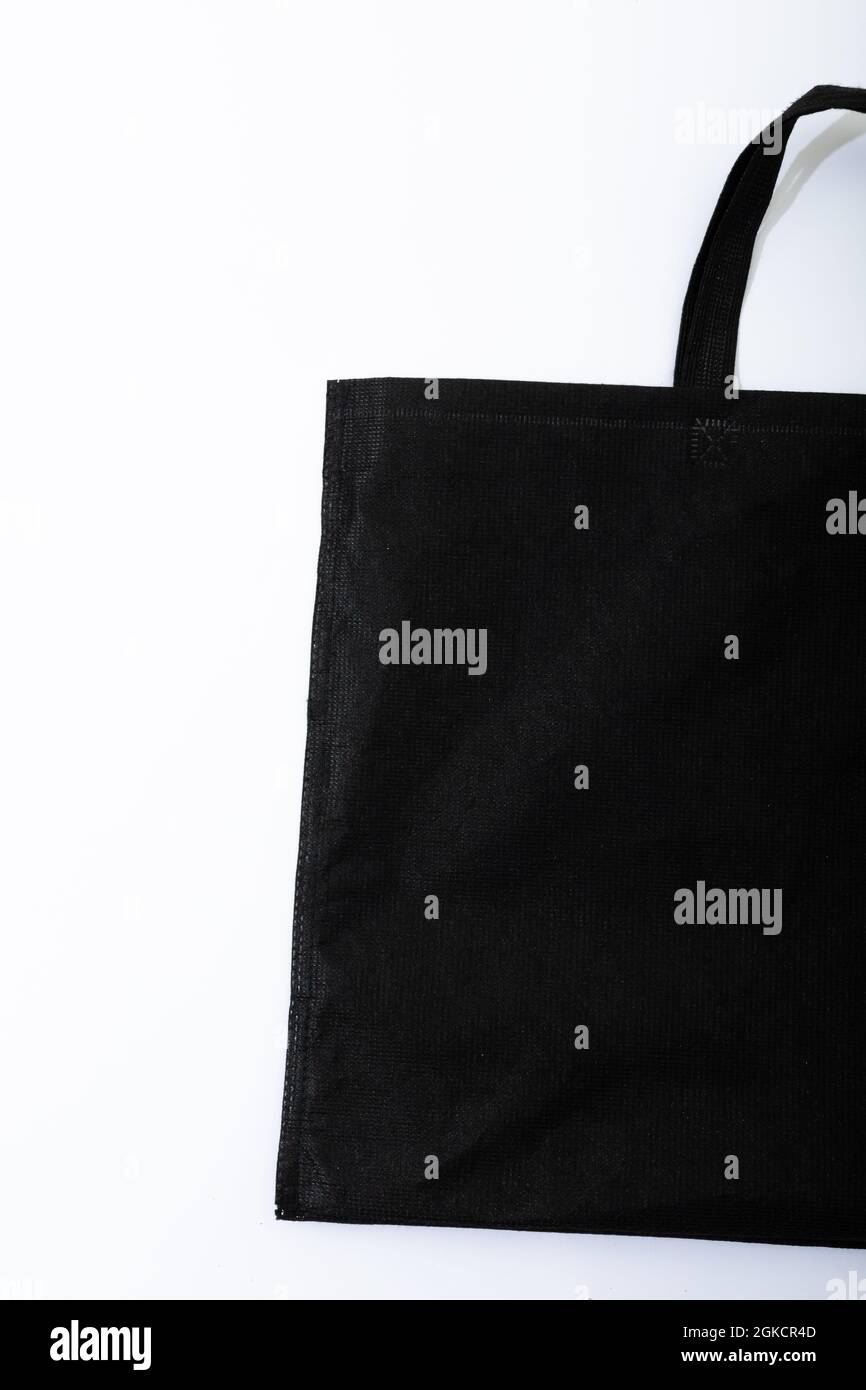 Composition of empty blag canvas shopping bag lying flat on white ...