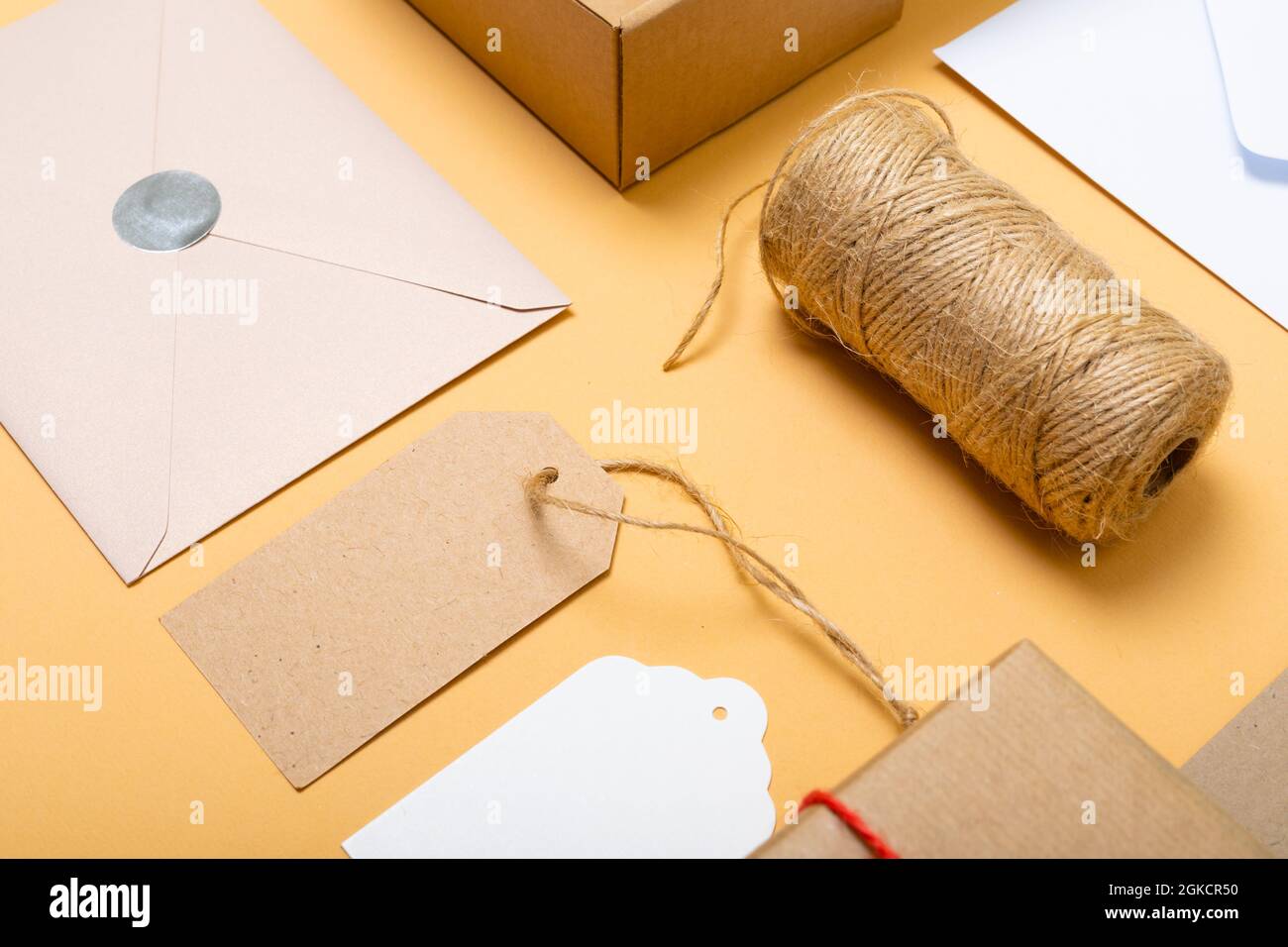 Composition of boxes, envelopes and gift tags on yellow background ...