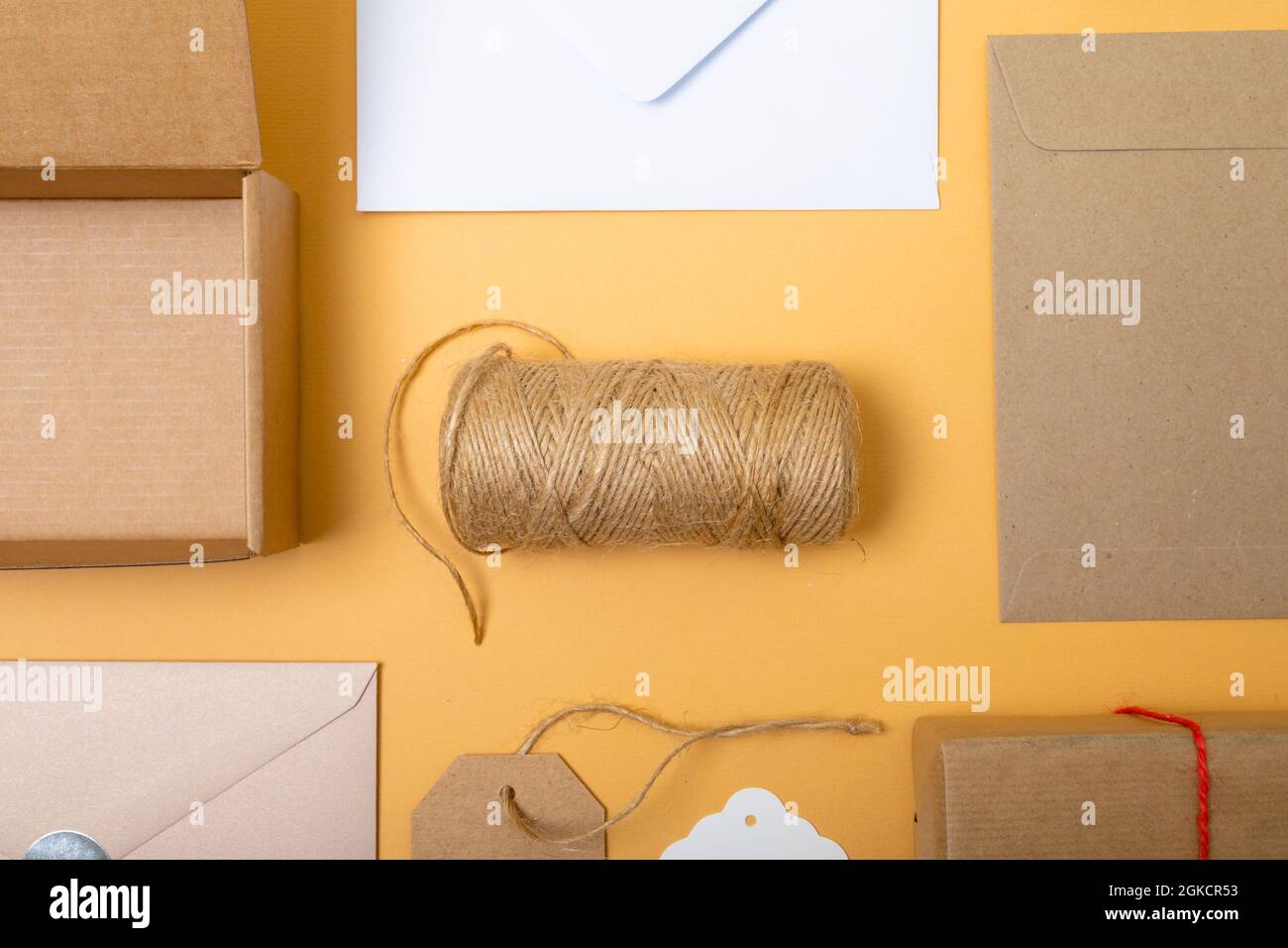 Composition of boxes, envelopes and gift tags on yellow background ...