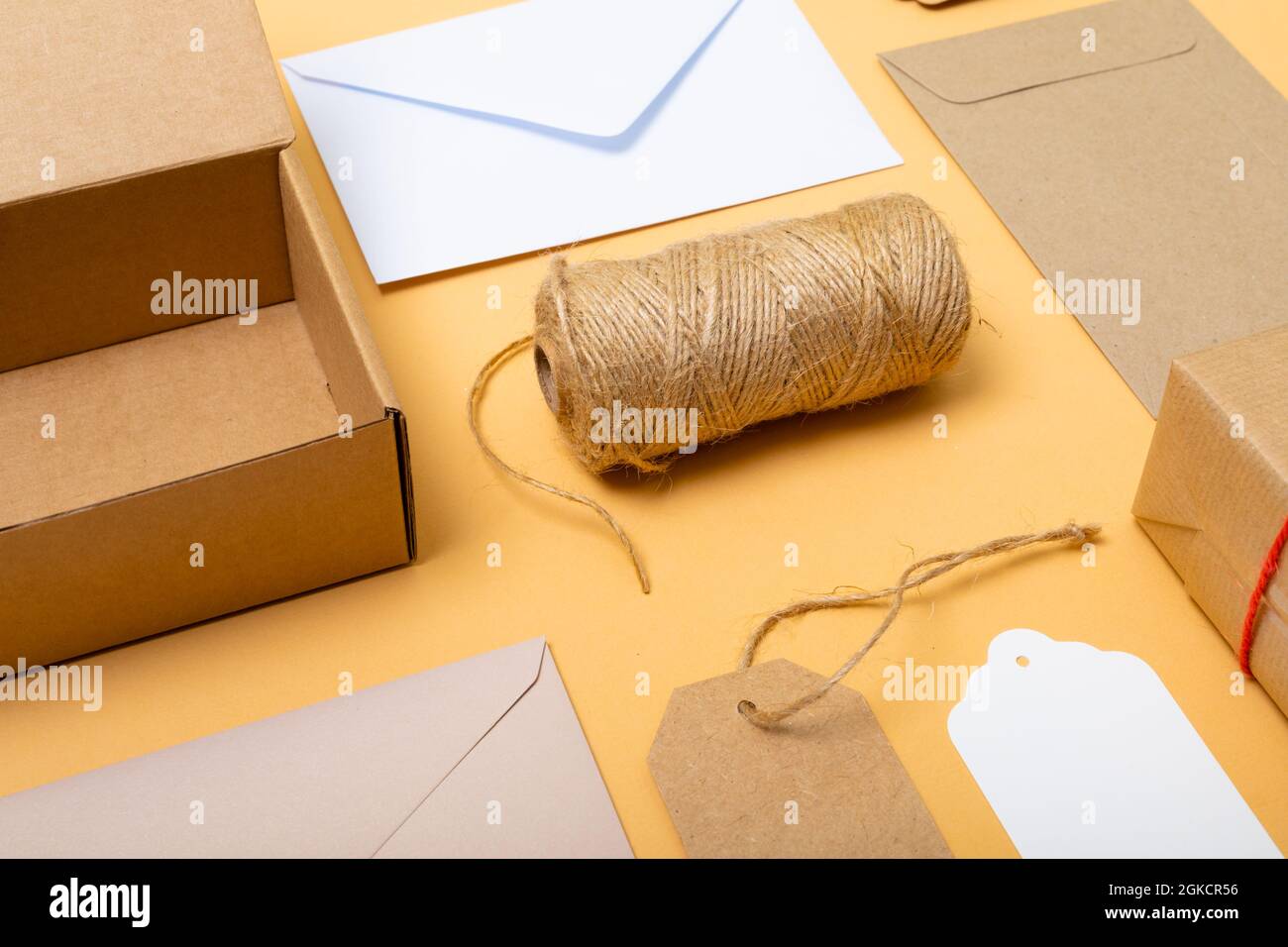 Composition of boxes, envelopes and gift tags on yellow background ...