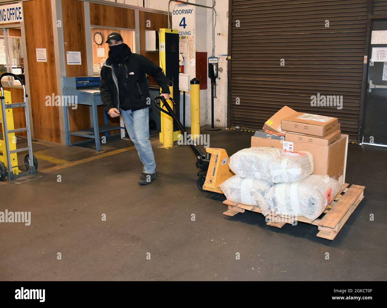 Christian Araujo moves a pallet of depot level repairable items from ...