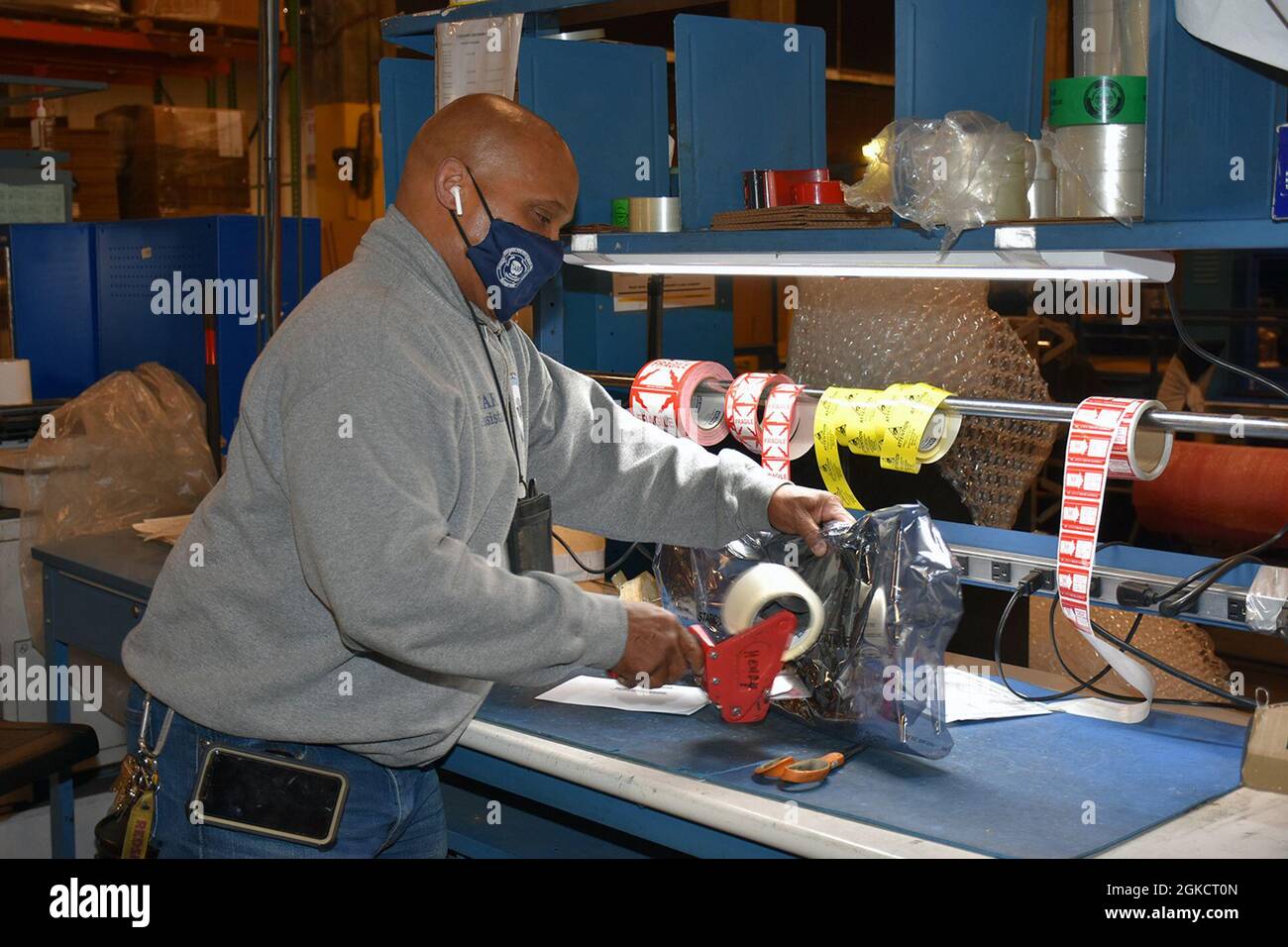 Henry Hunter prepares a depot level repairable item for packaging Stock ...
