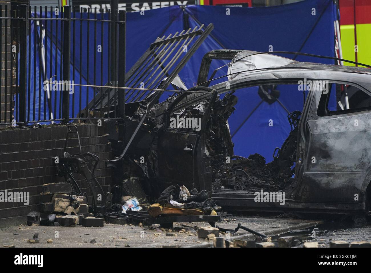 The burnt out shell of a car at the scene on the Great Western Road ...