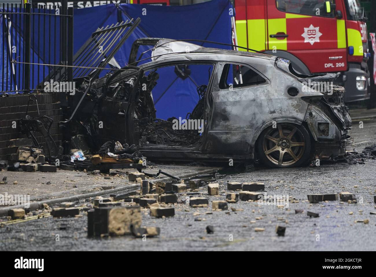 The burnt out shell of a car at the scene on the Great Western Road ...
