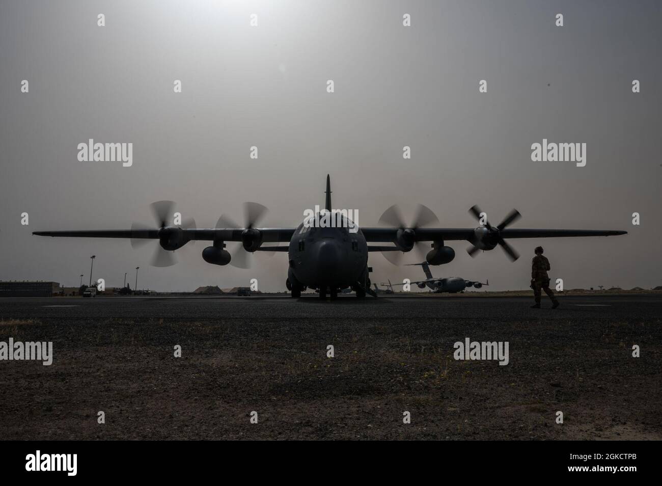 A U.S. Air Force loadmaster watches as the engines start up on a C-130 ...