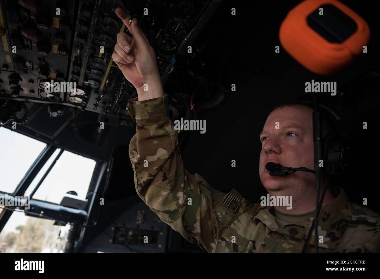 A U.S. Air Force flight engineer starts up engines on a C-130 Hercules ...