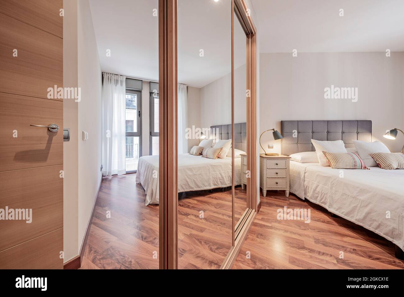 bedroom reflection in wardrobe doors with oak colored bezels Stock ...