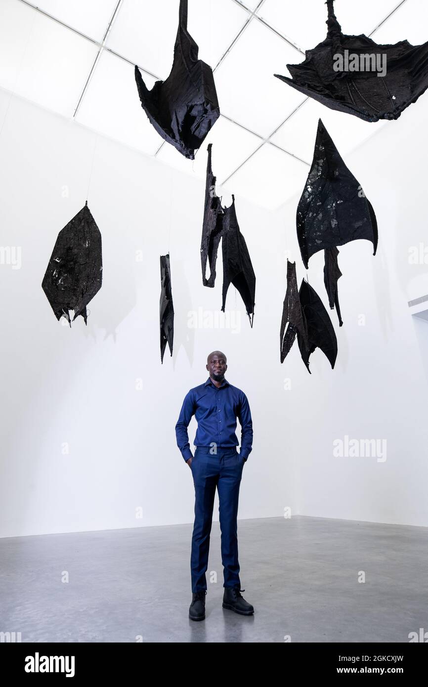 London, UK. 14 September 2021. Ibrahim Mahama pictured with his artwork ...