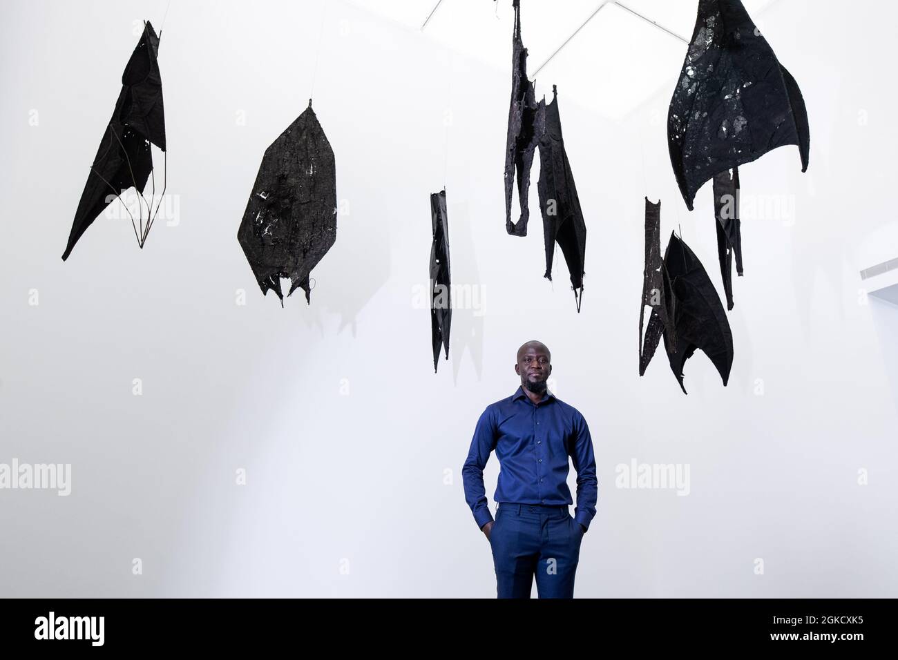 London, UK. 14 September 2021. Ibrahim Mahama pictured with his artwork ...