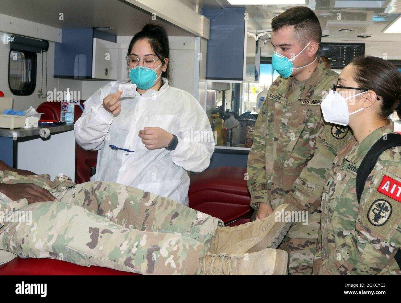 A laboratory technician with the Armed Services Blood Program instructs ...