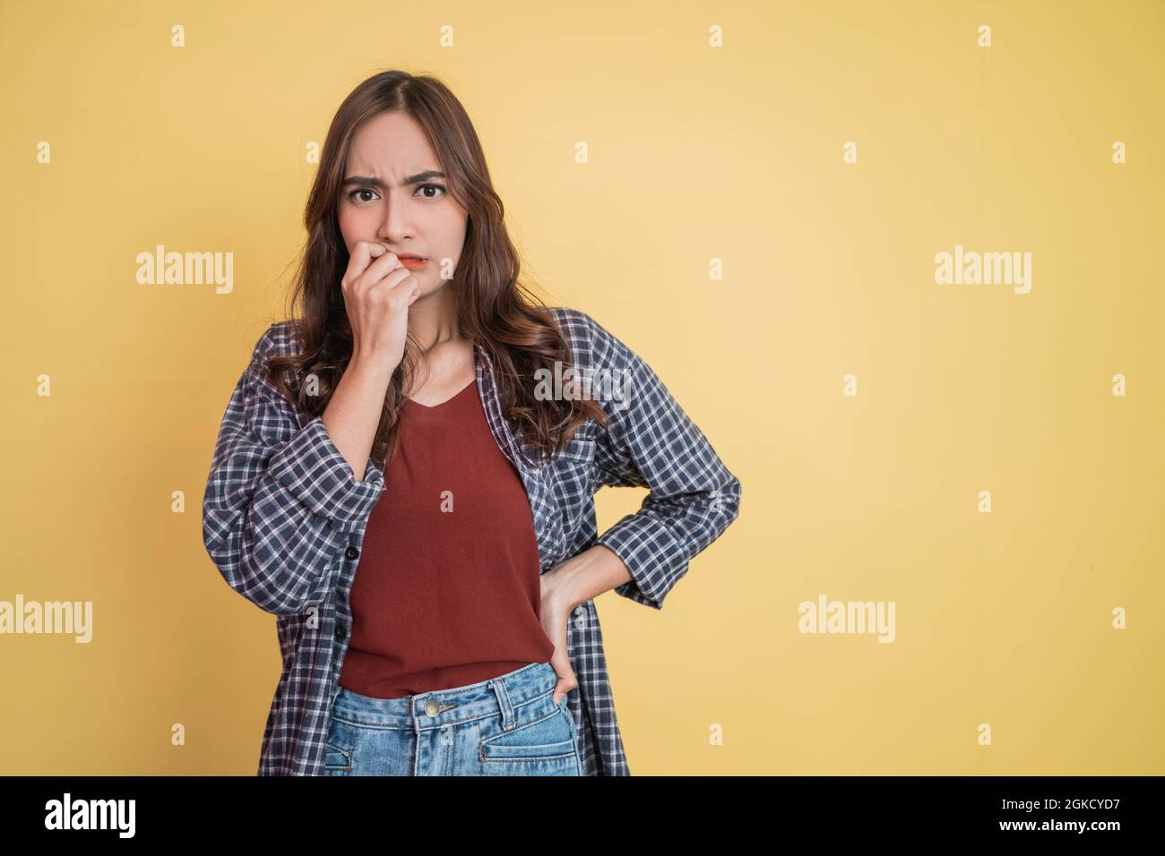 Asian girl biting finger hi-res stock photography and images - Alamy