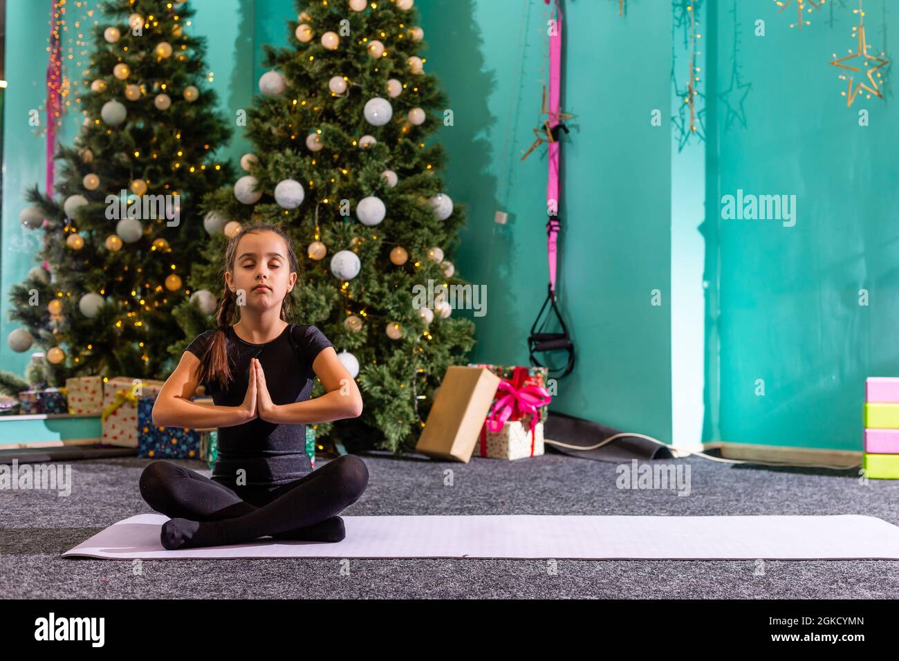 Merry Christmas and a happy new year. Little girl workout at home in ...