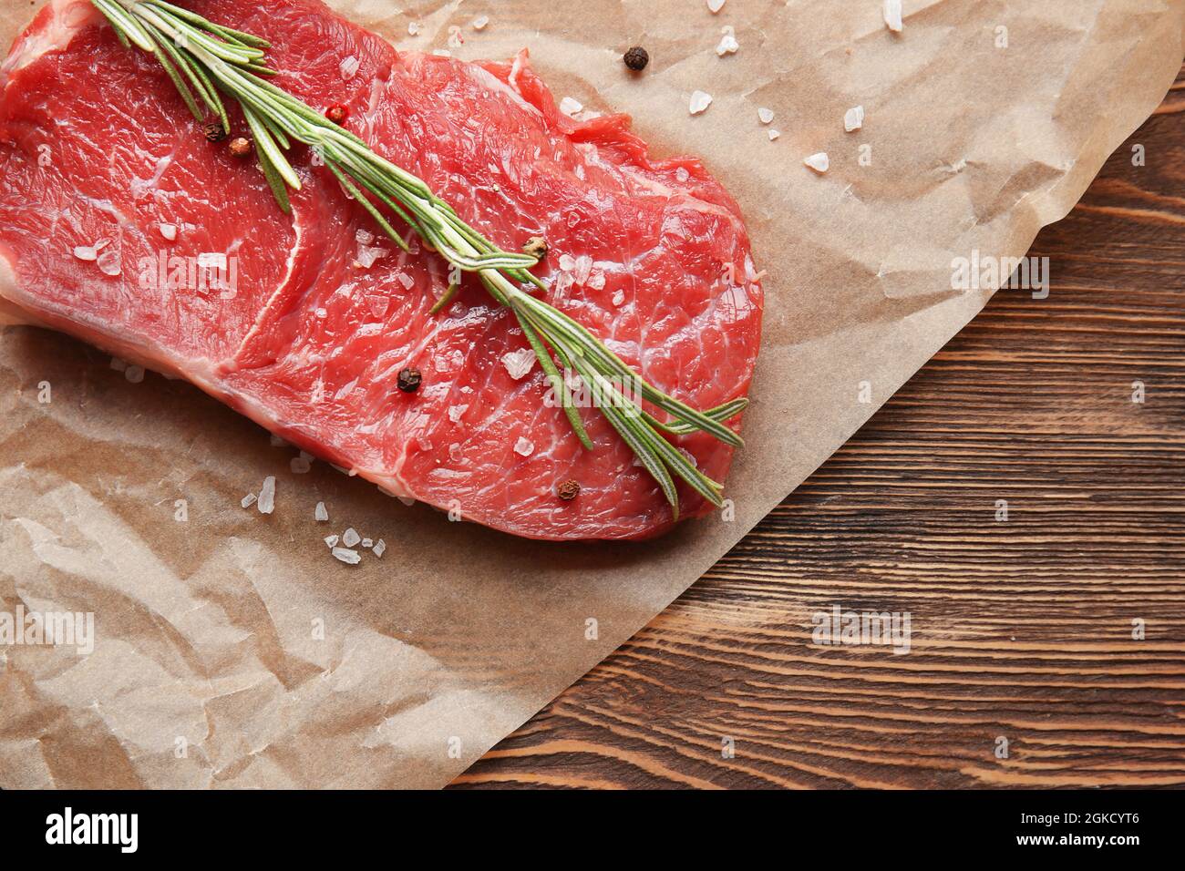 Fresh raw meat with spice on parchment paper Stock Photo - Alamy