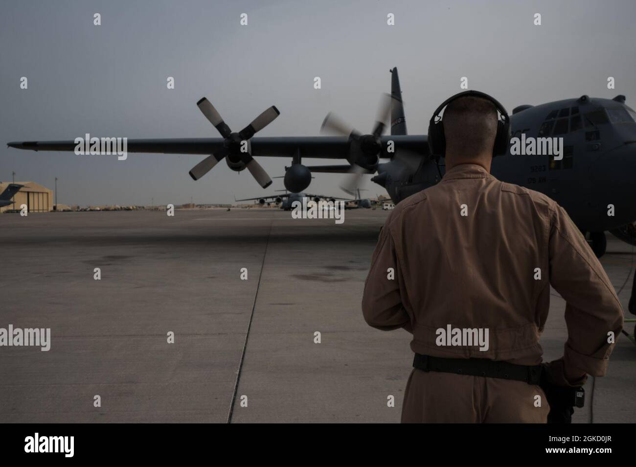 A U.S. Air Force loadmaster watches as the engines start up on a C-130 ...