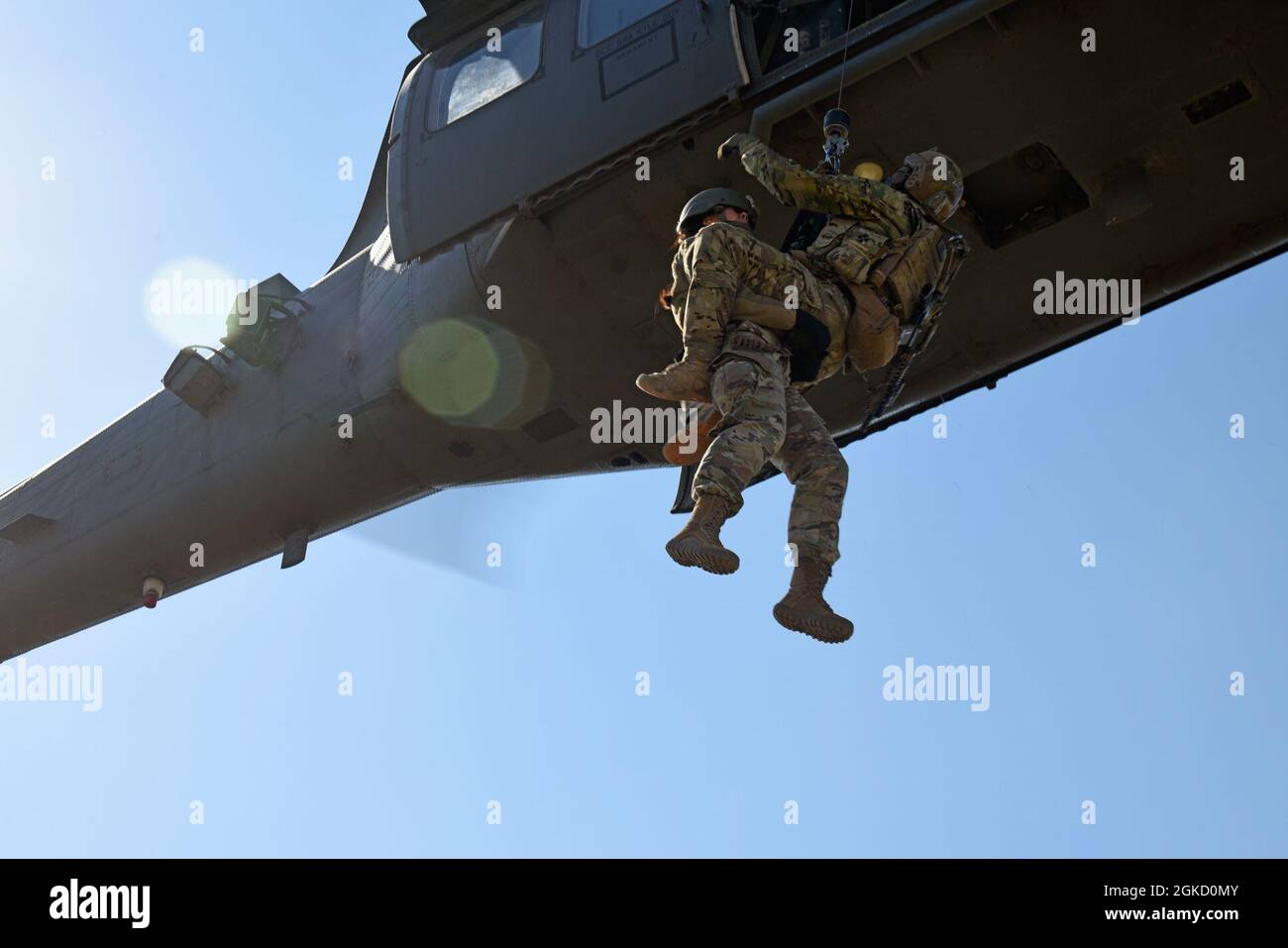 A U.S. Air Force pararescueman and survivor are hoisted up into an HH-60 Pave Hawk at the ...