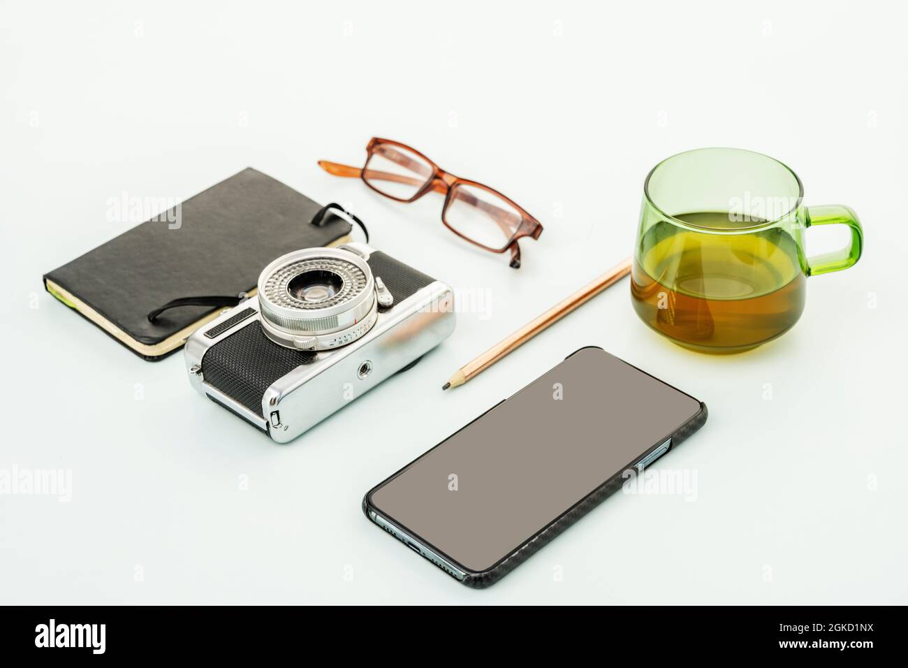 vintage photo camera with smartphone and cup of tea with rose gold ...