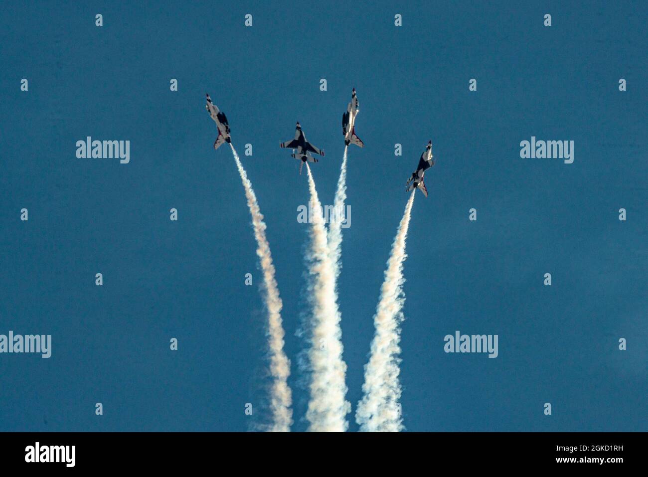 The U.S. Thunderbirds fly in the background of F-15SG Strike Eagles ...