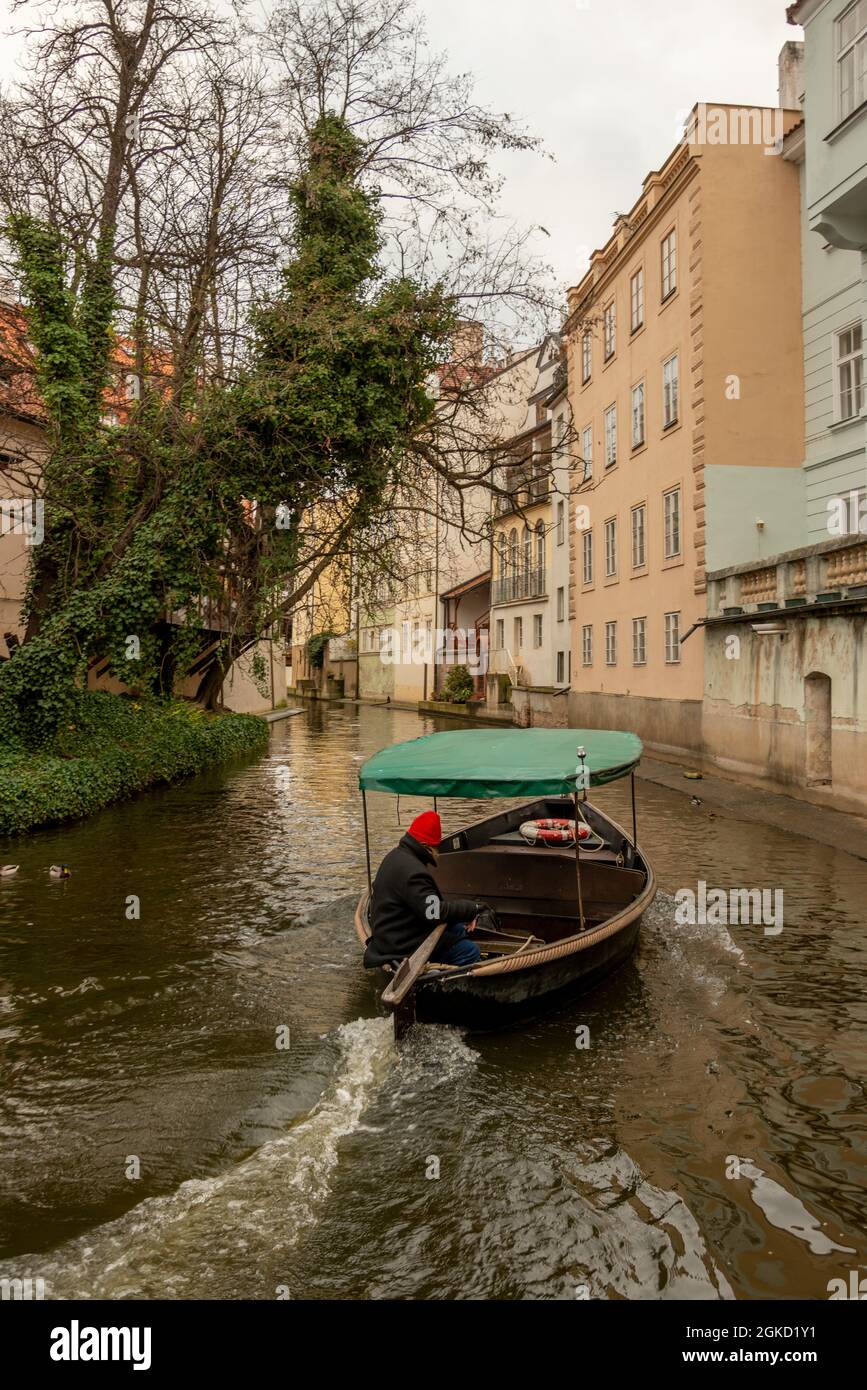 Raft with sailor navigating a canal next to the Danube in the city of ...