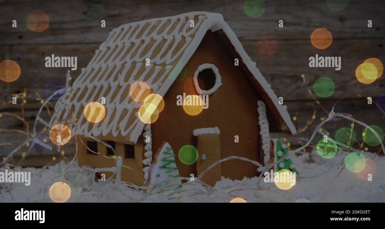 Image of spots of light over gingerbread house in snow Stock Photo - Alamy