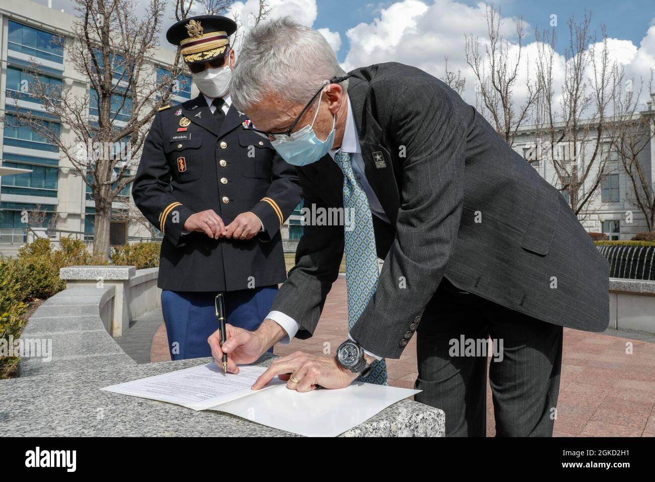 Dr. John Mitchell signs his oath of office after he was sworn in as a ...
