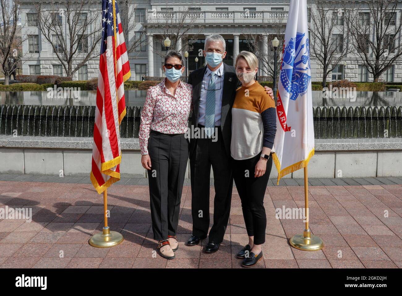 Dr. John Mitchell takes a photo with his wife and daughter after he ...