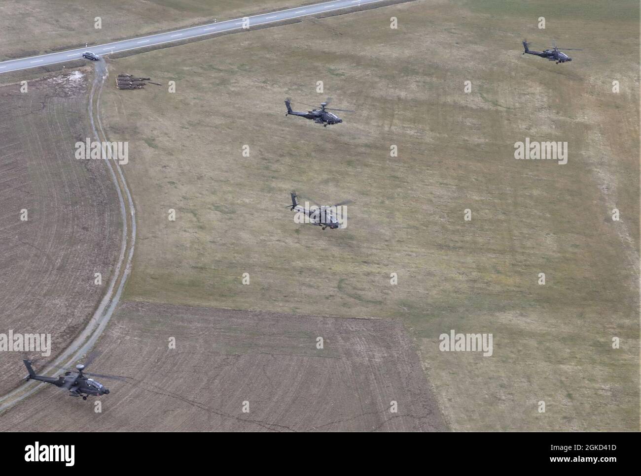 A line of Apache helicopters hover over ground during Operation Eminent ...