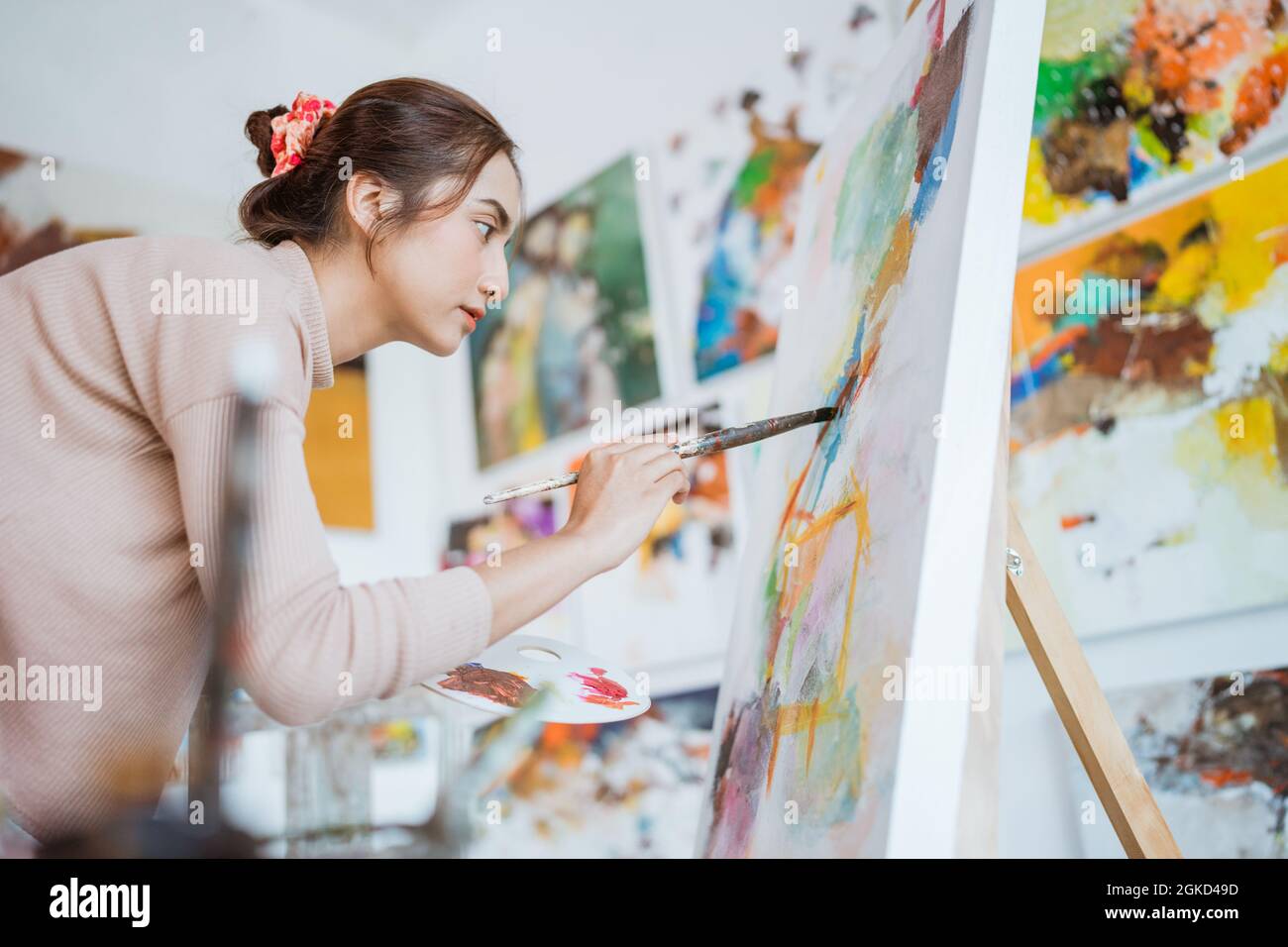 female artist working on her painting in studio Stock Photo - Alamy