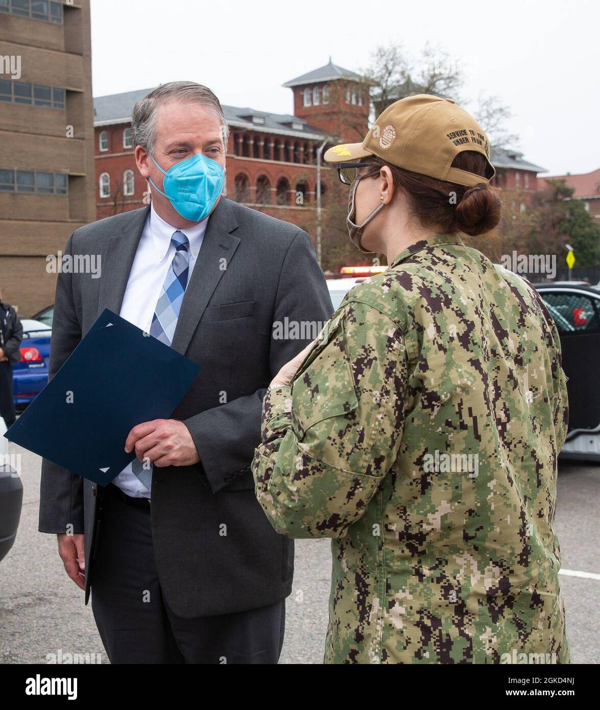 Acting Secretary of the Navy Thomas W. Harker is presented a memento by ...