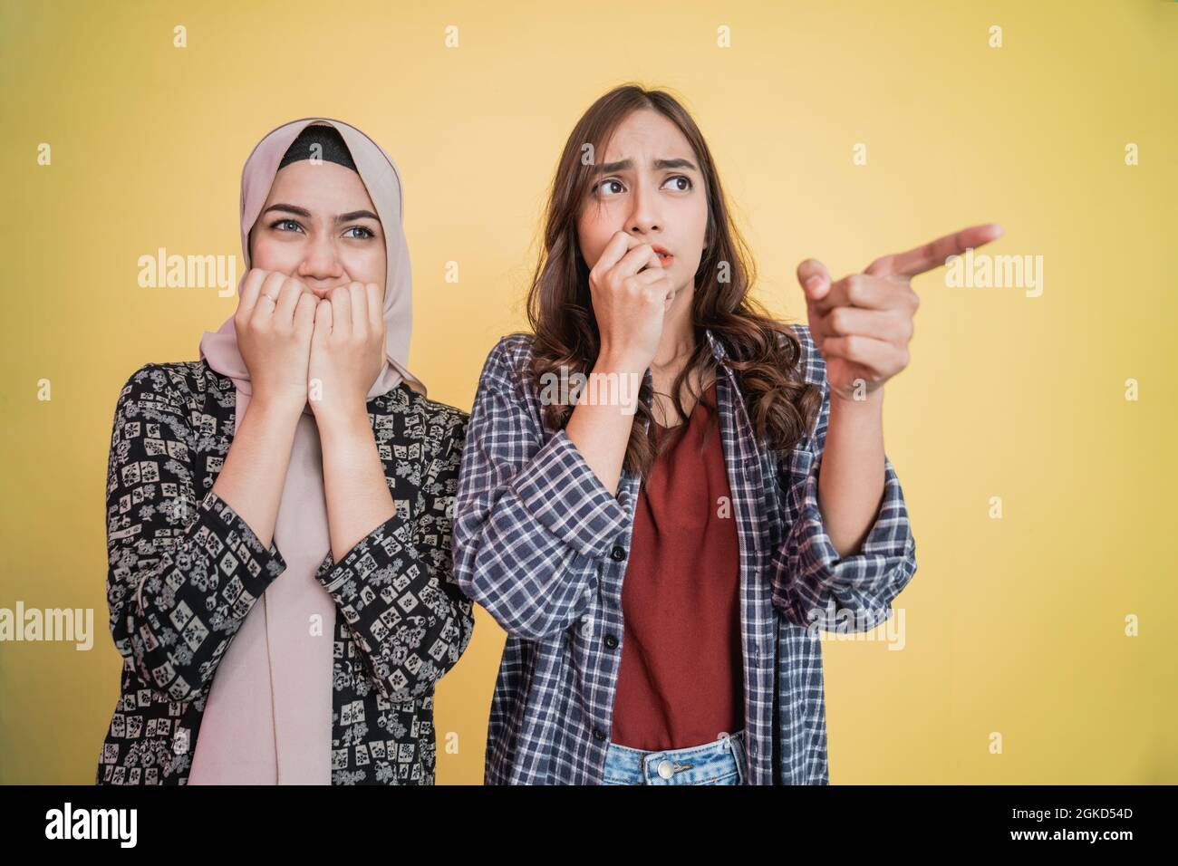 two asian girls scared expression with finger pointing gesture Stock ...