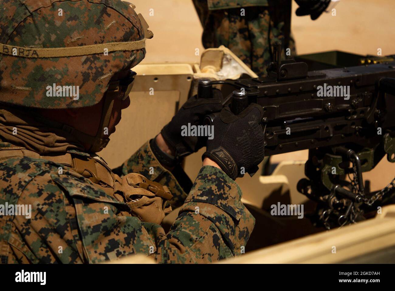 A U.S. Marine with 7th Marine Regiment, 1st Marine Division, fires an ...