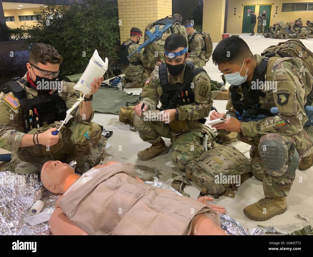 Sgt. Carter McCall (left) simulates point of injury care while CPT ...