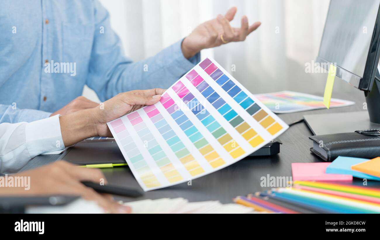 Graphic designer or creative working together coloring using graphics ...